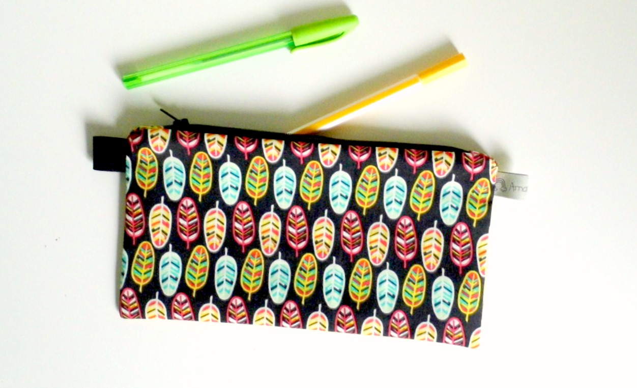 Trousse pour l'école imprimée plumes multicolores sur fond noir